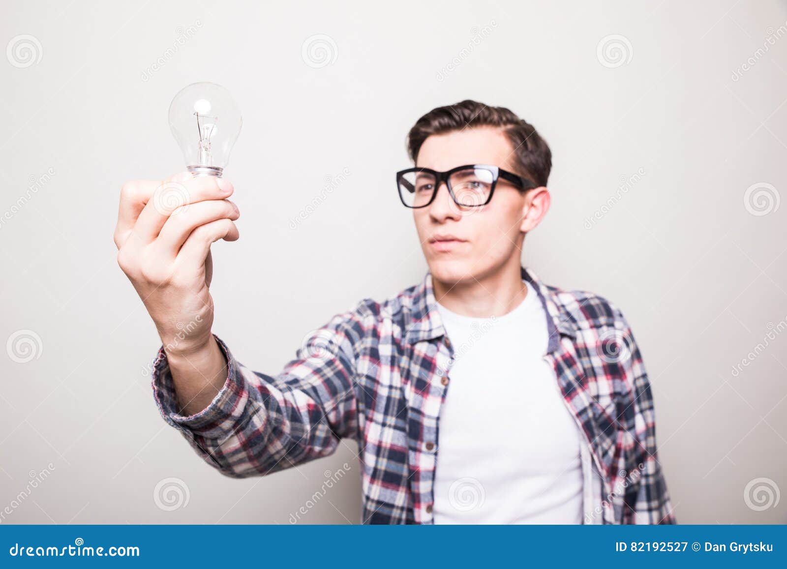 Man Standing and Looking at Light Bulb Stock Image - Image of handsome ...
