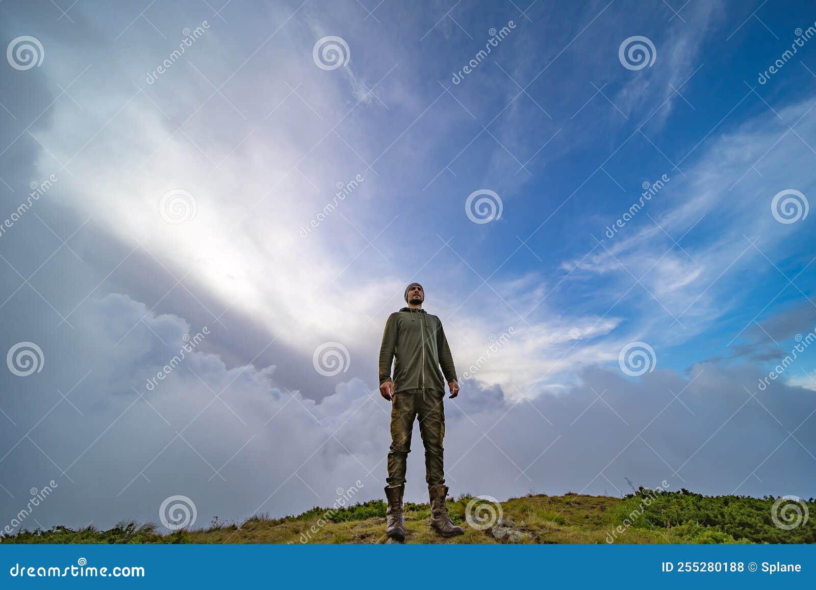The Man Standing on the Mountain on a Cloudy Sky Background. Stock ...