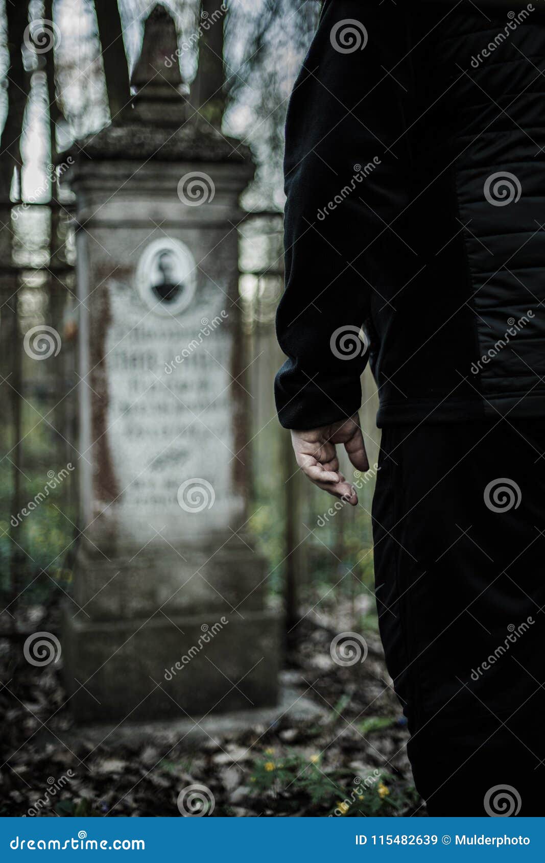 Man standing near tomb stock image. Image of adult, graveyard - 115482639