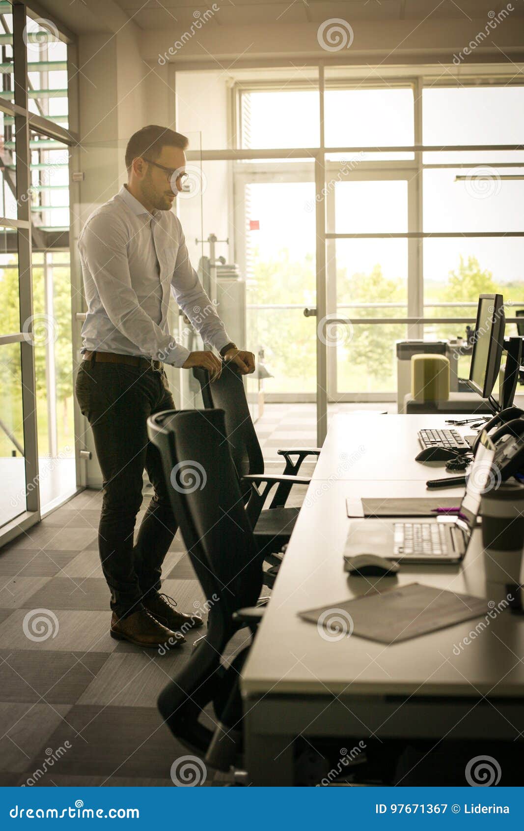 .Man Standing Next To the Table and Looking at Something Stock Image ...