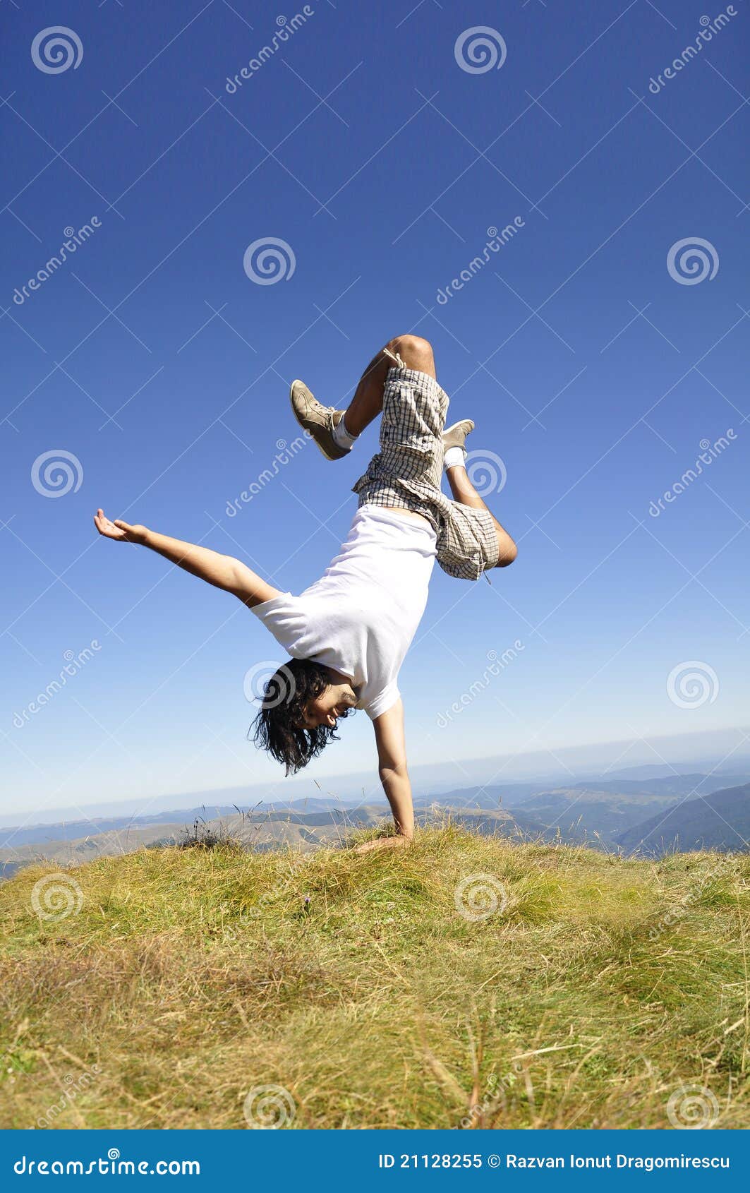 Man standing on one hand stock image. Image of action - 21128255