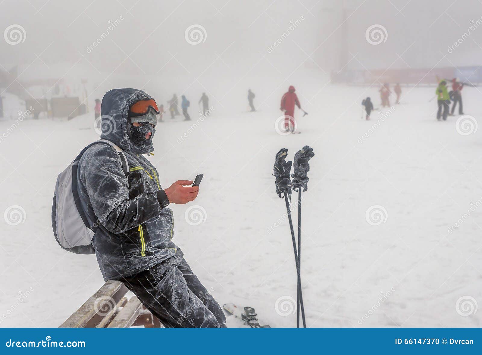 Man Standing Outdoor on the Snow and Fog and Texting on Smartphone ...
