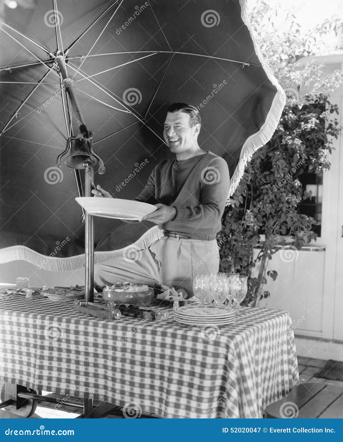 Man Standing at a Picnic Table and Holding a Plate Stock Image - Image ...