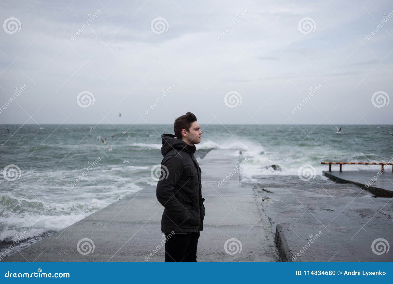 The Man is Standing on the Pier Facing the Wind Stock Photo - Image of ...