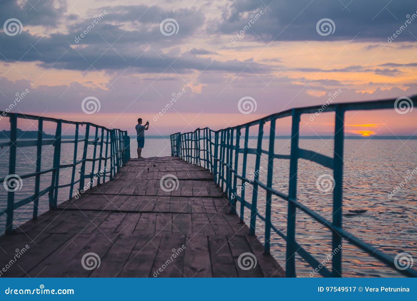 Man Standing on the Pier and Looking on Sunset Stock Image - Image of ...