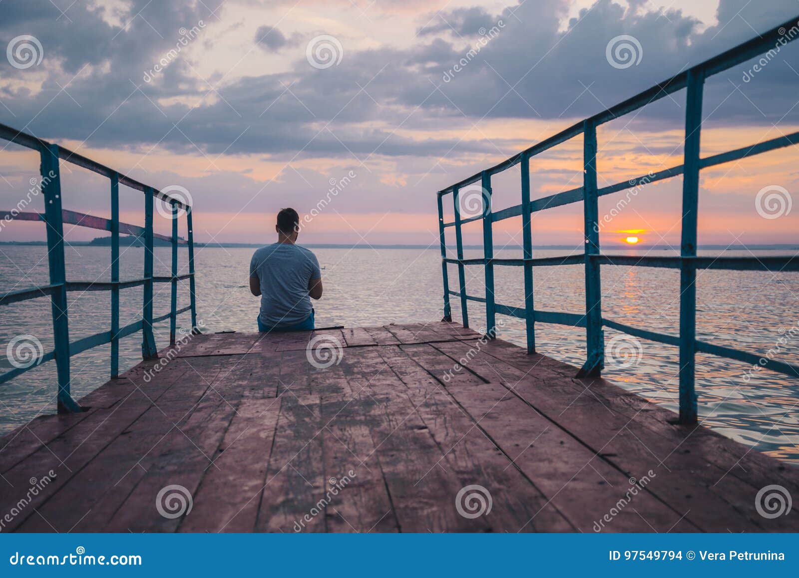 Man Standing on the Pier and Looking on Sunset Stock Photo - Image of ...