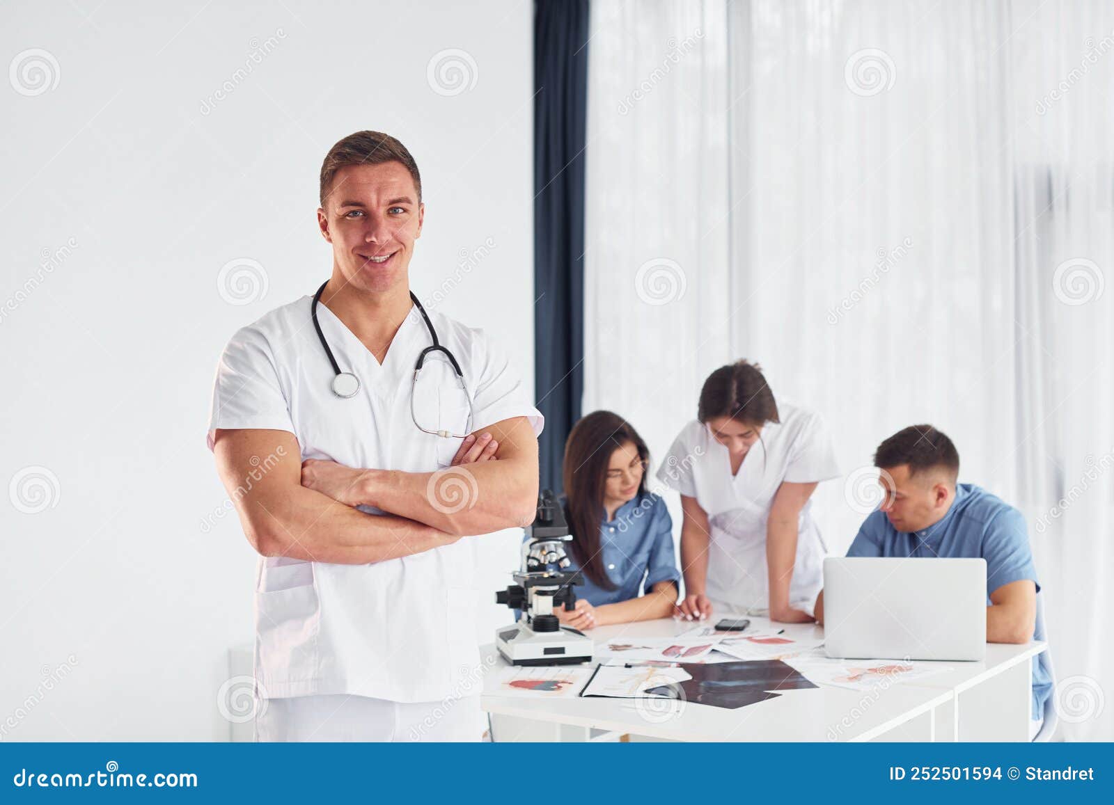 Man Standing and Posing. Group of Young Doctors is Working Together in ...