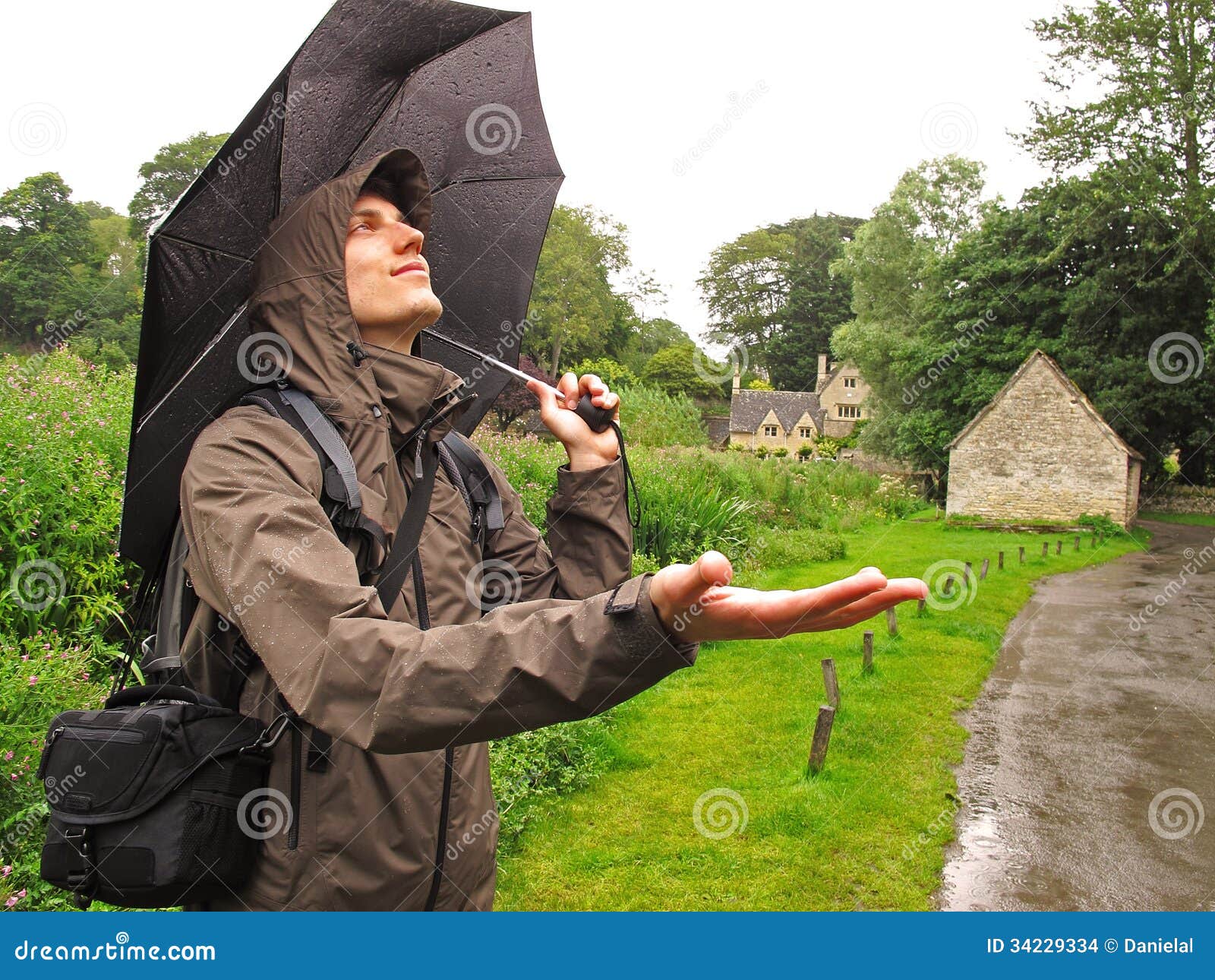 Man standing in the rain stock photo. Image of house - 34229334