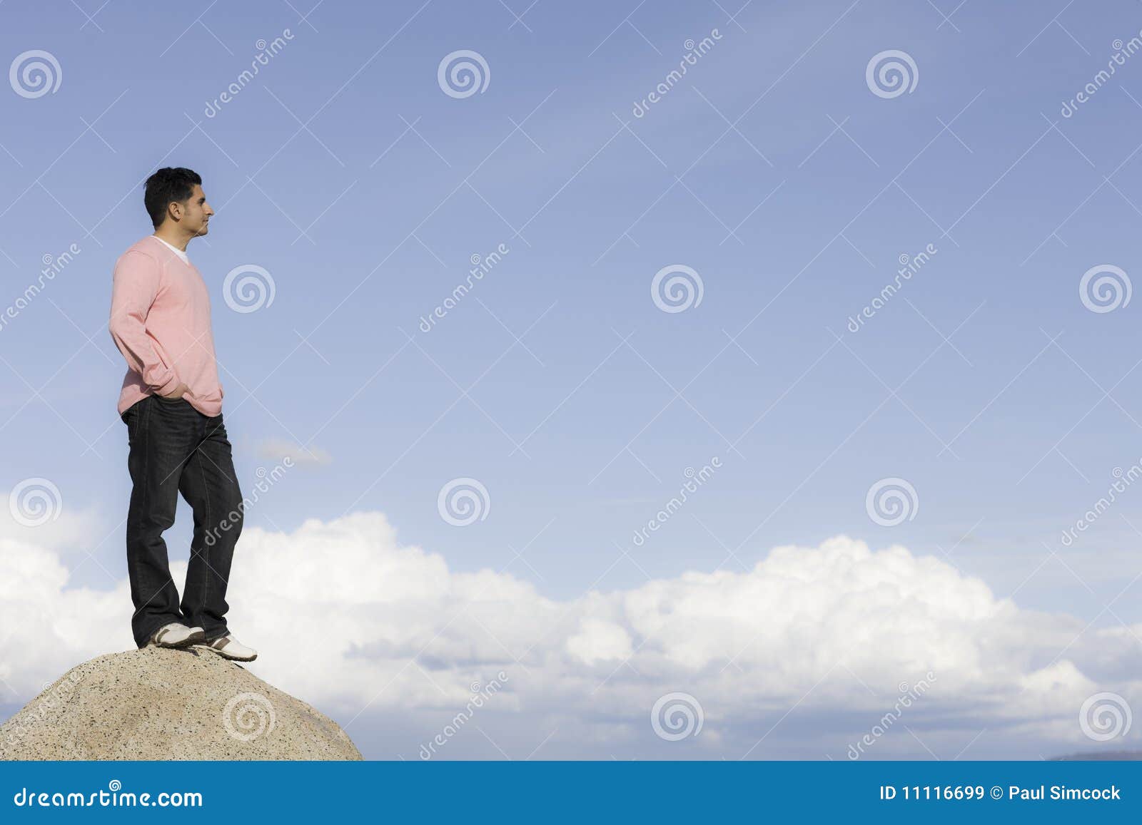 Man Standing on Rock Looking into Distance Stock Image - Image of ...