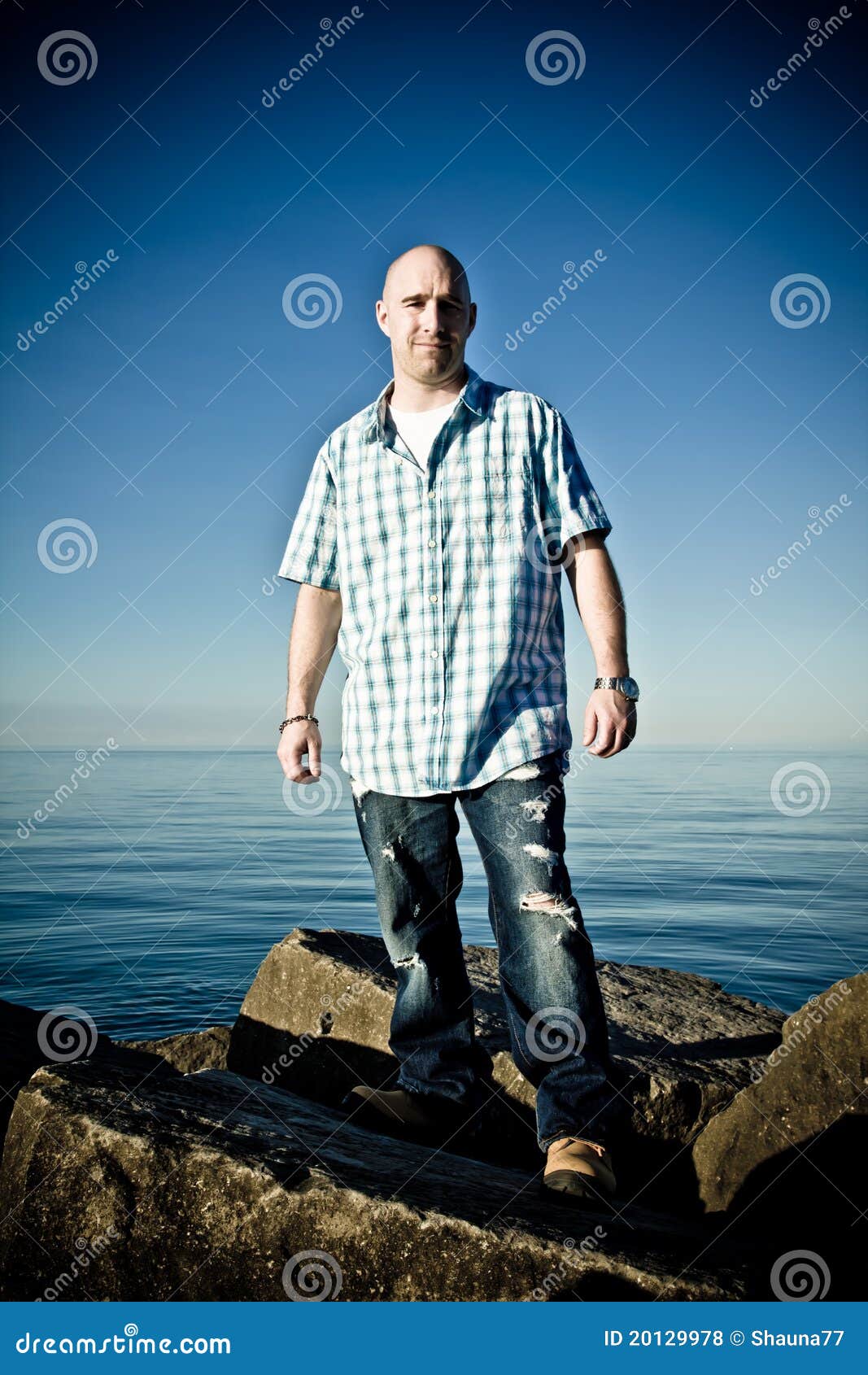 Man Standing on rocks stock photo. Image of leaning, male - 20129978