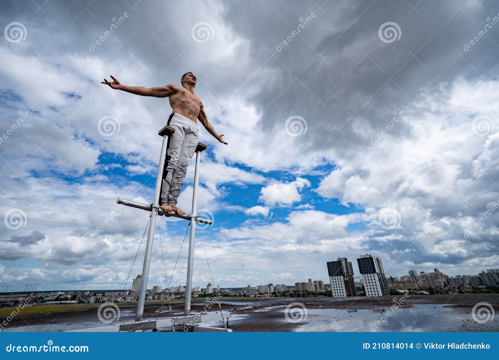 Man Standing on the Rooftop with Dramatic Clouds and Cityscape on ...