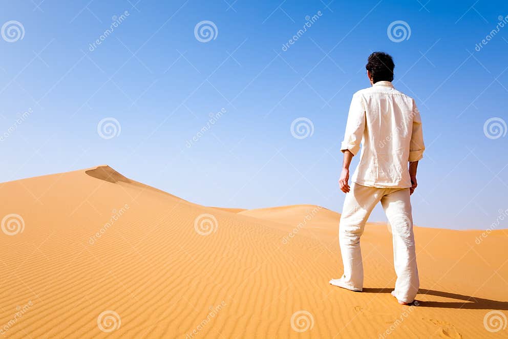 Man Standing on a Sand Dune Stock Image - Image of outdoors, dune: 8740557
