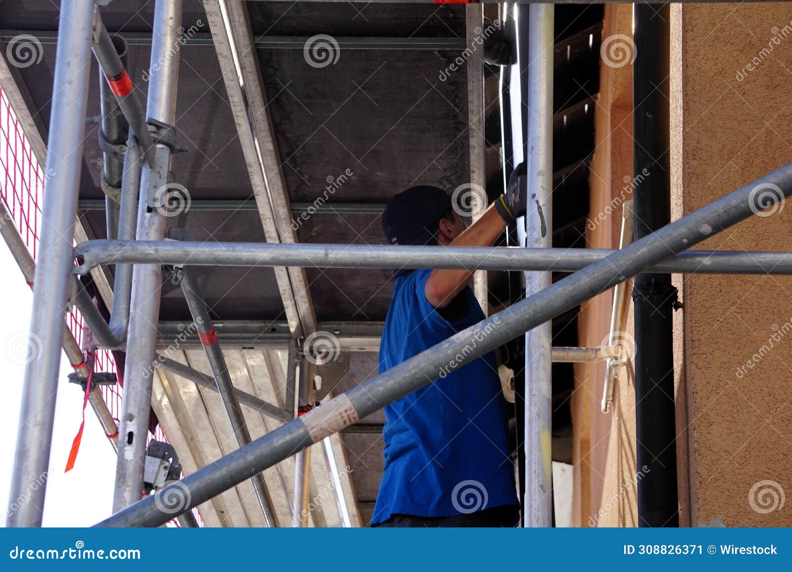 A Man is Standing on a Scaffolding Platform Working Stock Image - Image ...