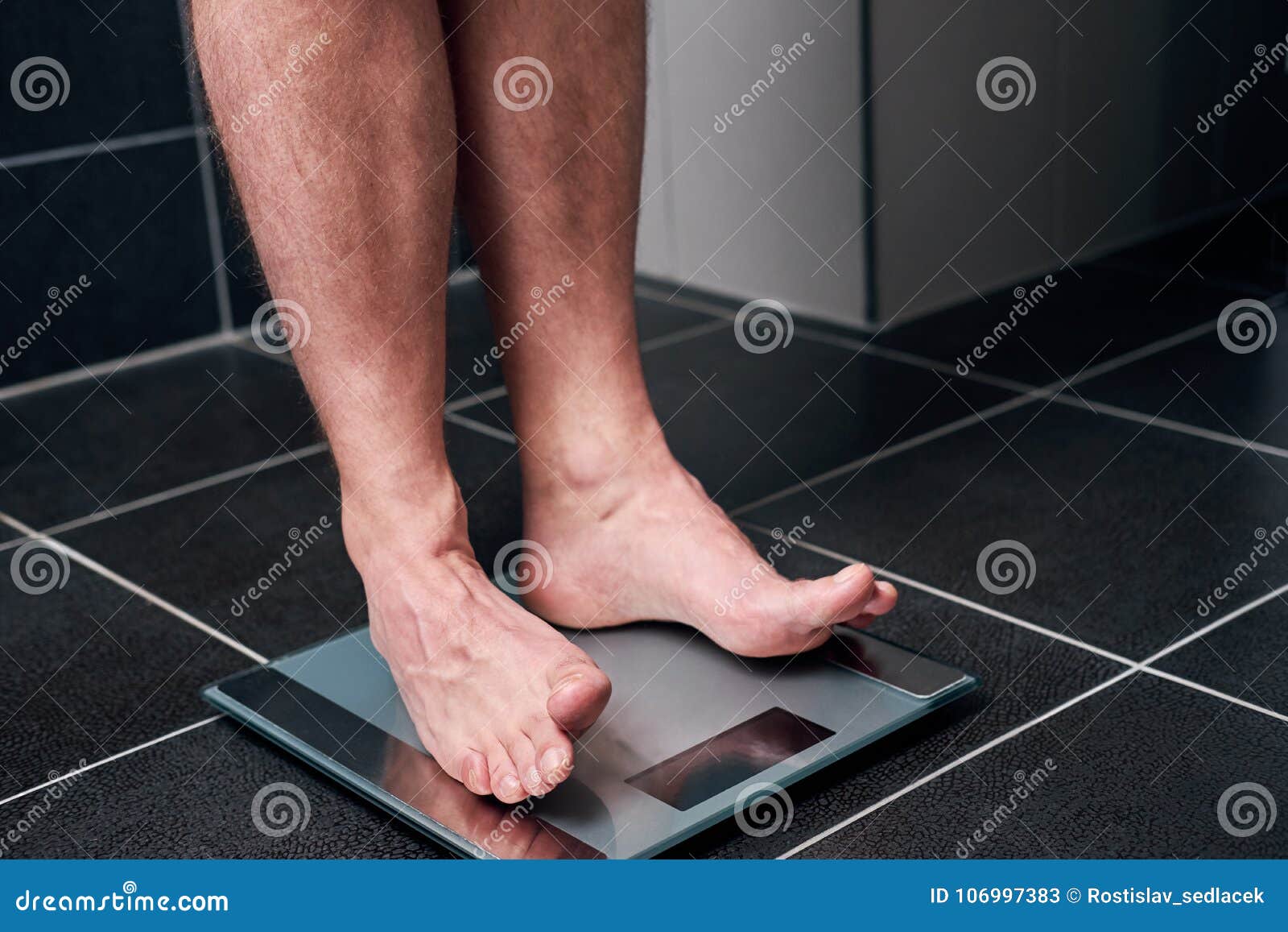 Man standing on a scale stock image. Image of bathroom - 106997383