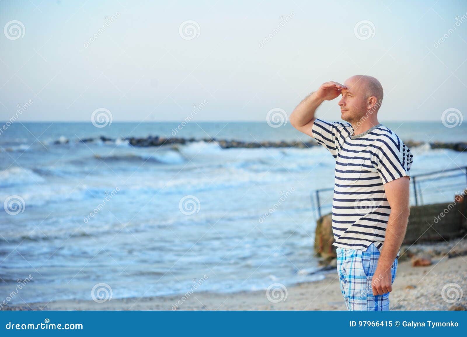 Man is Standing by the Sea and Looking into the Distance Stock Image ...