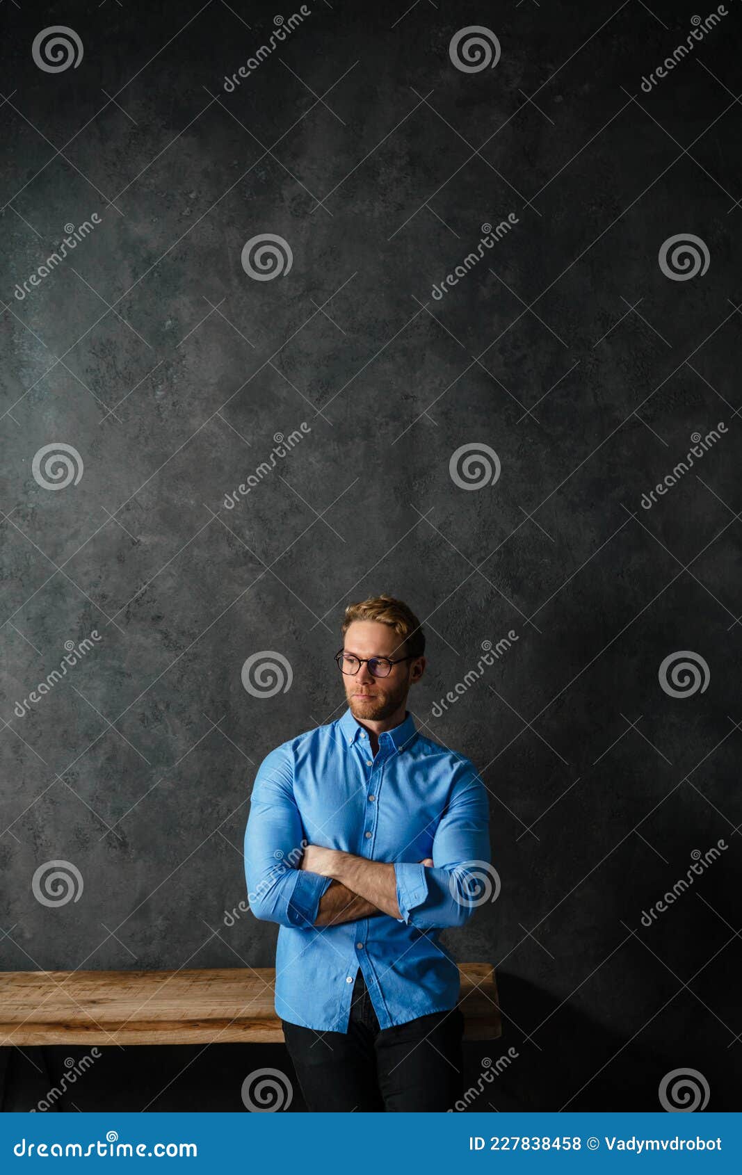 The Man in Standing while Sitting Down at the Table in the Studio Stock ...