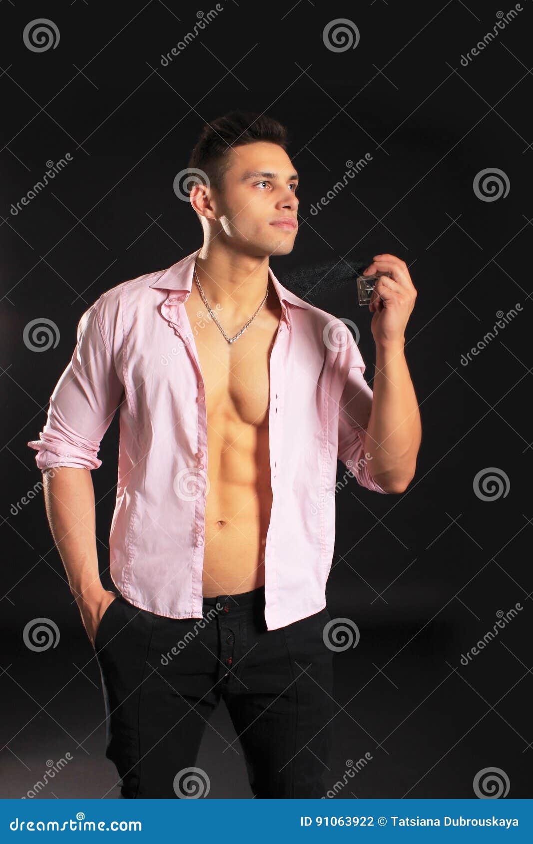 Man Standing and Spraying Perfume Over Himself. Stock Photo - Image of ...