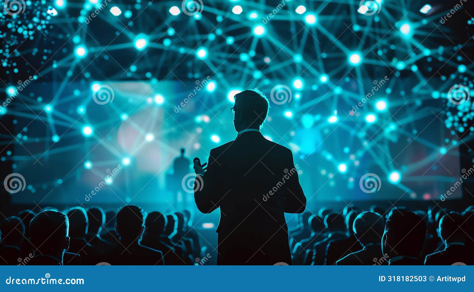 A Man Standing on a Stage Giving a Presentation in Front of a Large ...