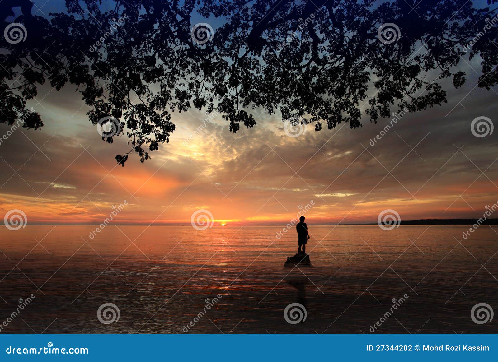 Man standing at a sunset stock photo. Image of horizon - 27344202