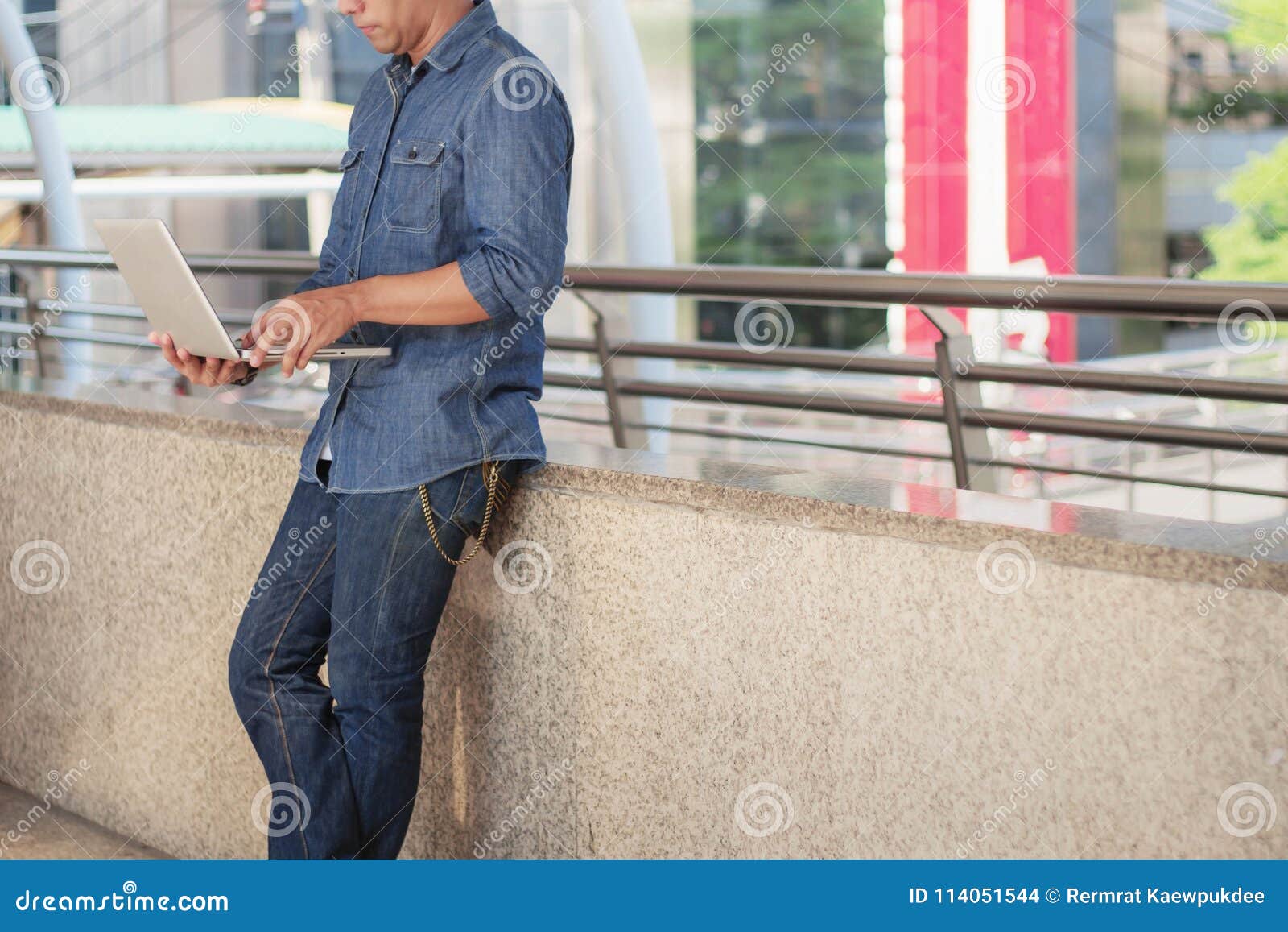 Man is Standing Using Computer. Stock Photo - Image of jeans, bangkok ...