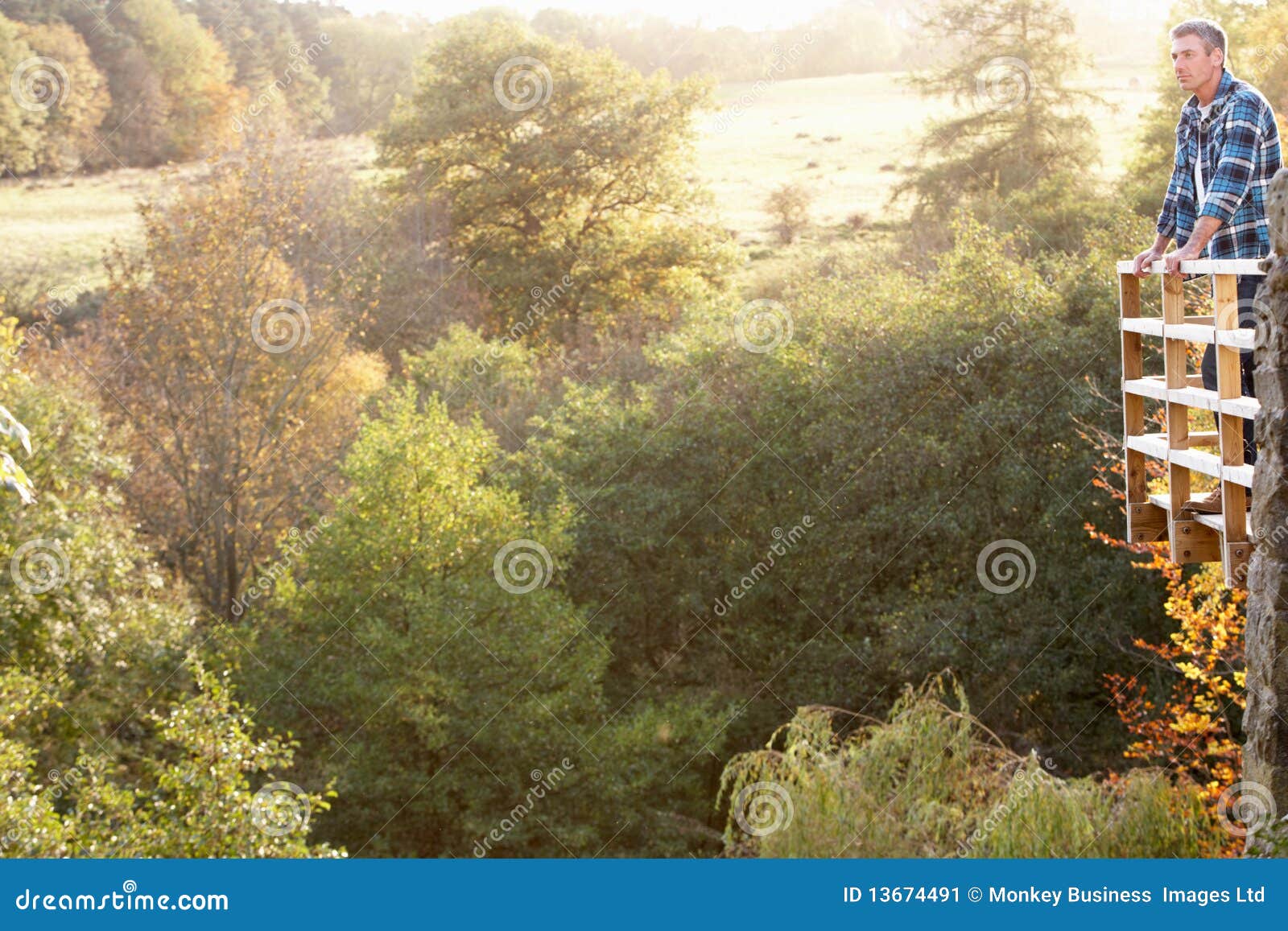 Man Standing on Wooden Balcony Overlooking Autumn Stock Image - Image ...