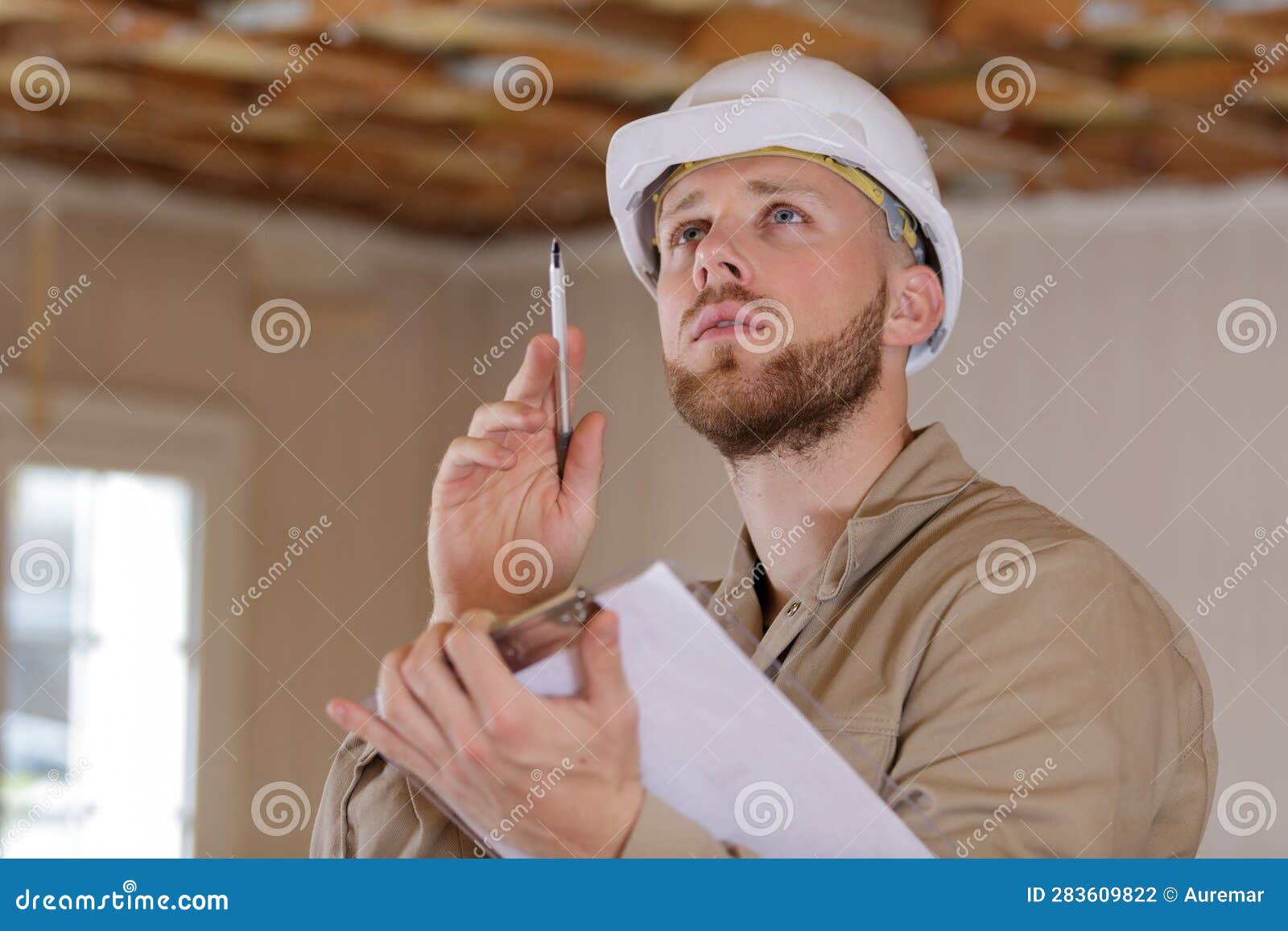 Man Standing and Writing in Folder Stock Photo - Image of business ...