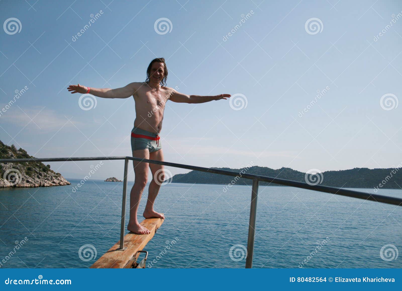 A Man Stands on a Board Behind the Yacht Stock Photo - Image of ...