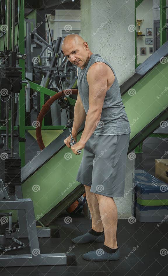 Man Stands in a Crossover Simulator and Performs an Exercise for ...