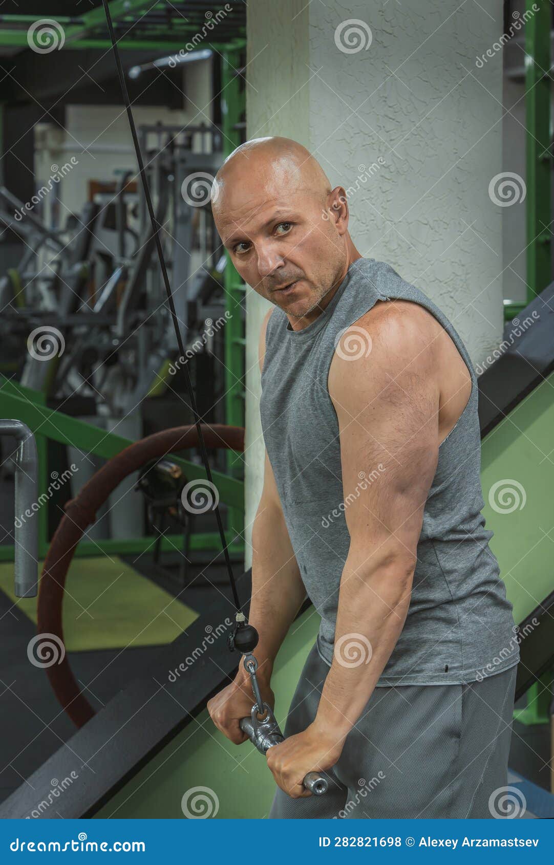 Man Stands in a Crossover Simulator and Performs an Exercise for ...