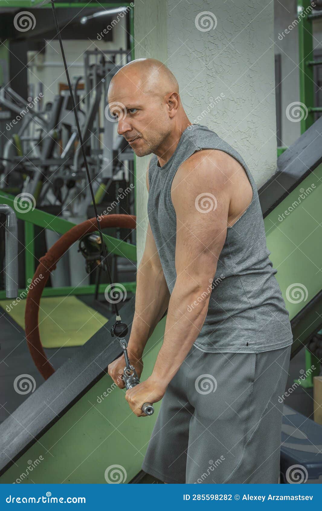 Man Stands in a Crossover Simulator and Performs an Exercise for ...