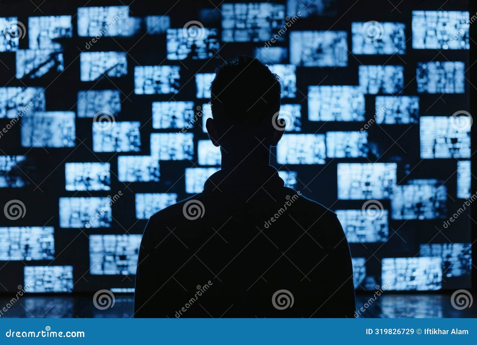 A Man Stands Facing a Big Screen Displaying Multiple Images, Depicting ...