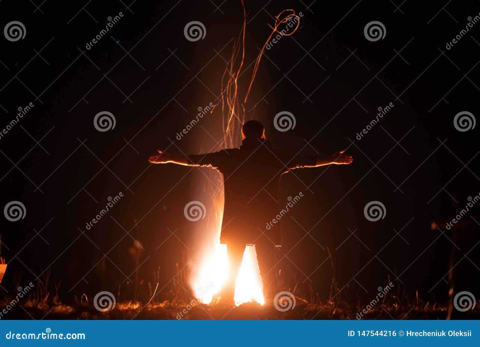 A Man Stands in Front of a Fire with Open Arms Stock Photo - Image of ...