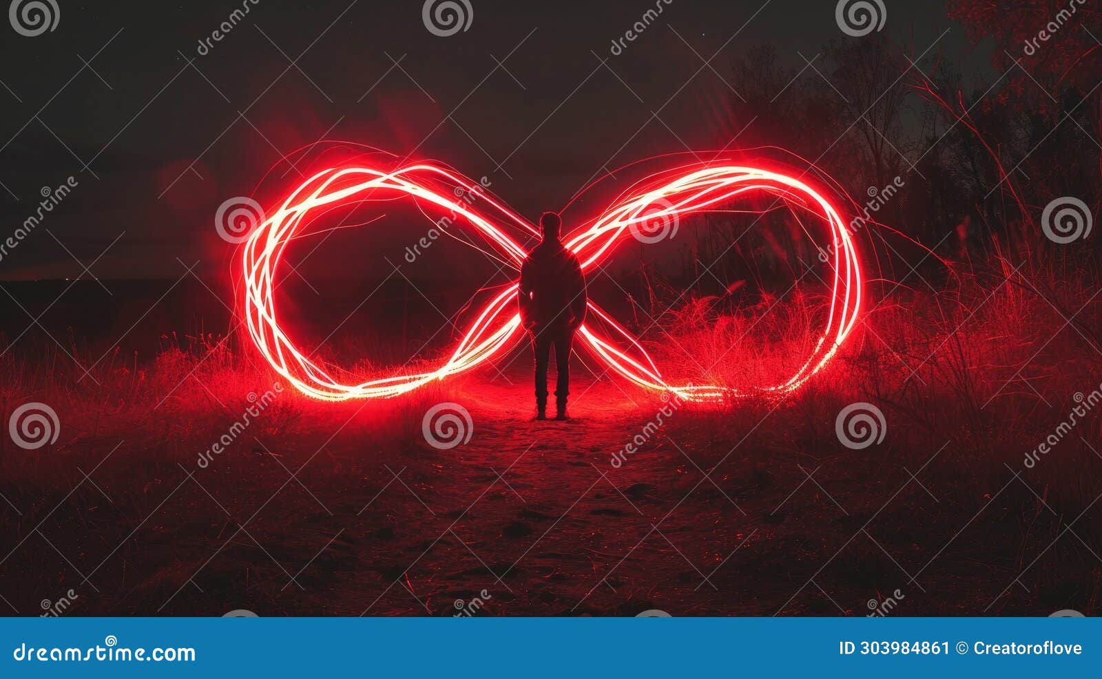 A Man Stands in Front of Red Infinity Neon Lights Symbol in Jungle ...