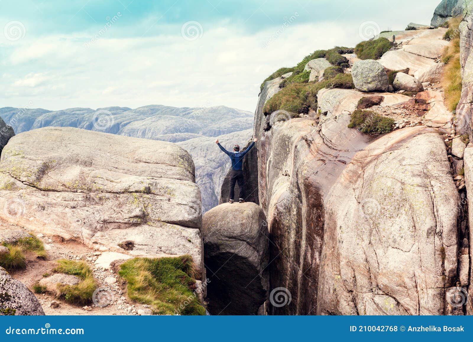A Man Stands on Kjerag Stone Stock Photo - Image of famous, fear: 210042768