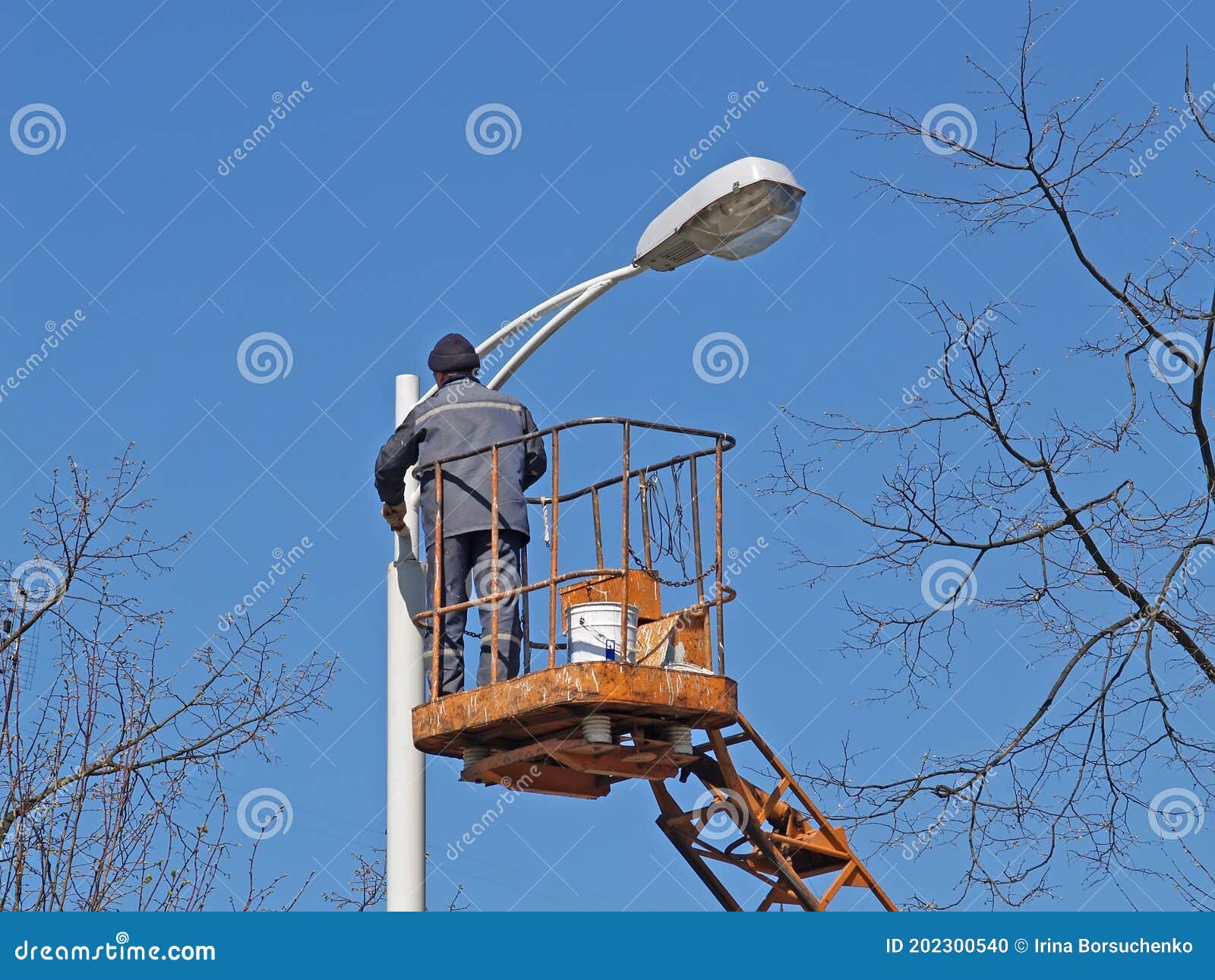 A Man Stands on a Tower and Paints a Lamppost Editorial Image - Image ...
