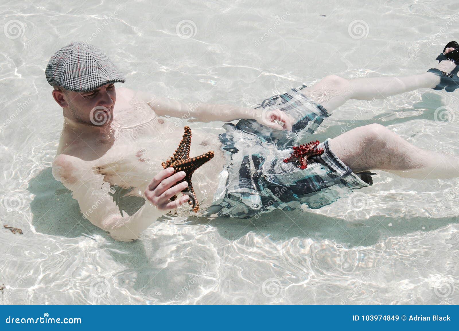 Man with a starfish stock image. Image of holiday, sunny - 103974849