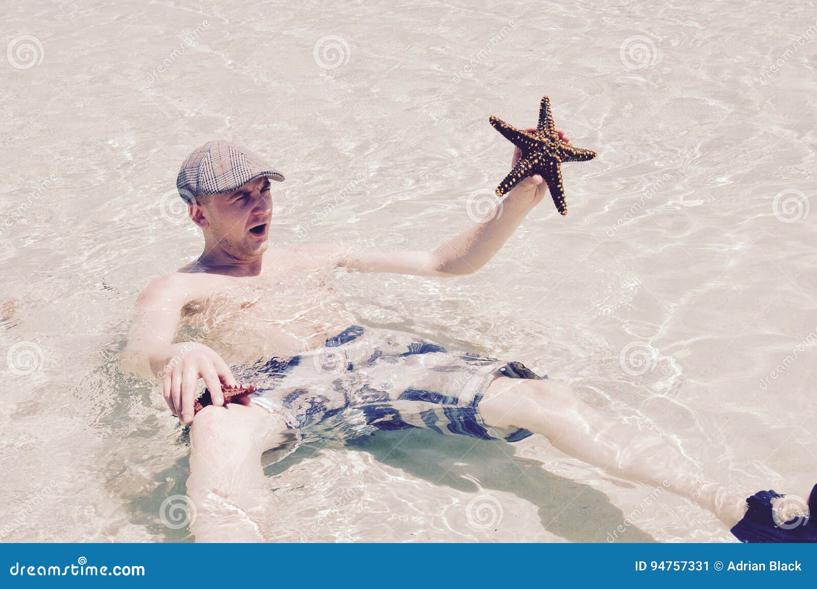 Man and starfish stock image. Image of ocean, starfish - 94757331