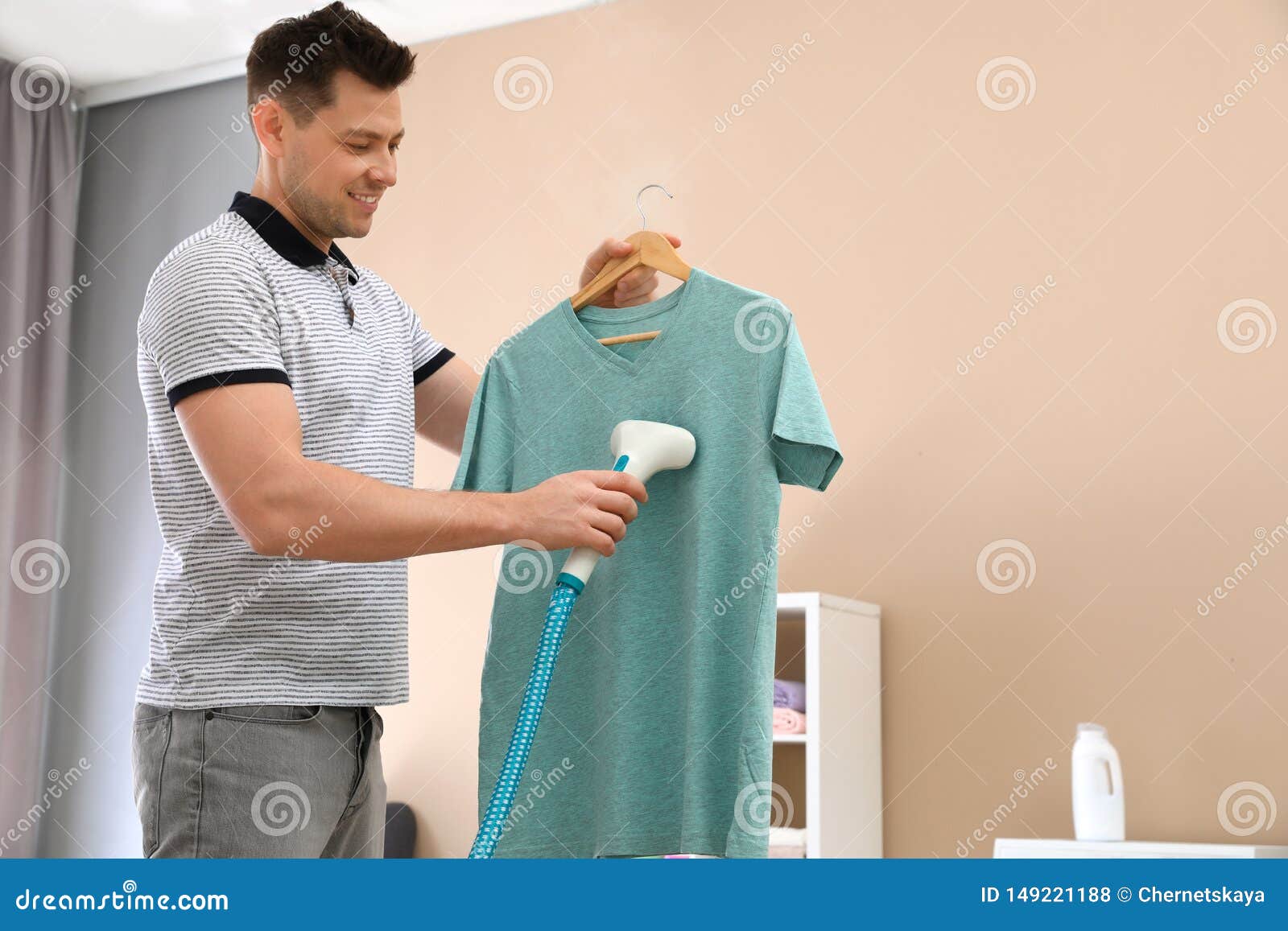 Man Steaming His Clothes in Living Room Stock Photo - Image of ironing ...