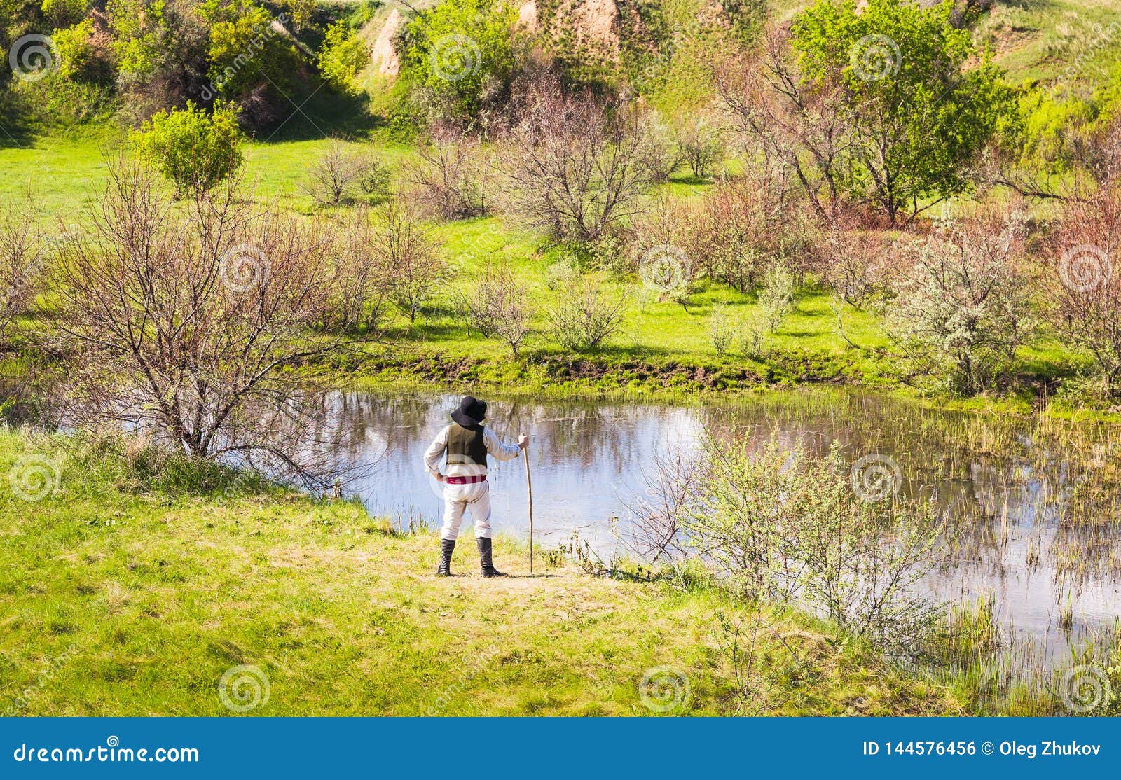 Man with a Stick Standing on the River Bank Stock Photo - Image of ...