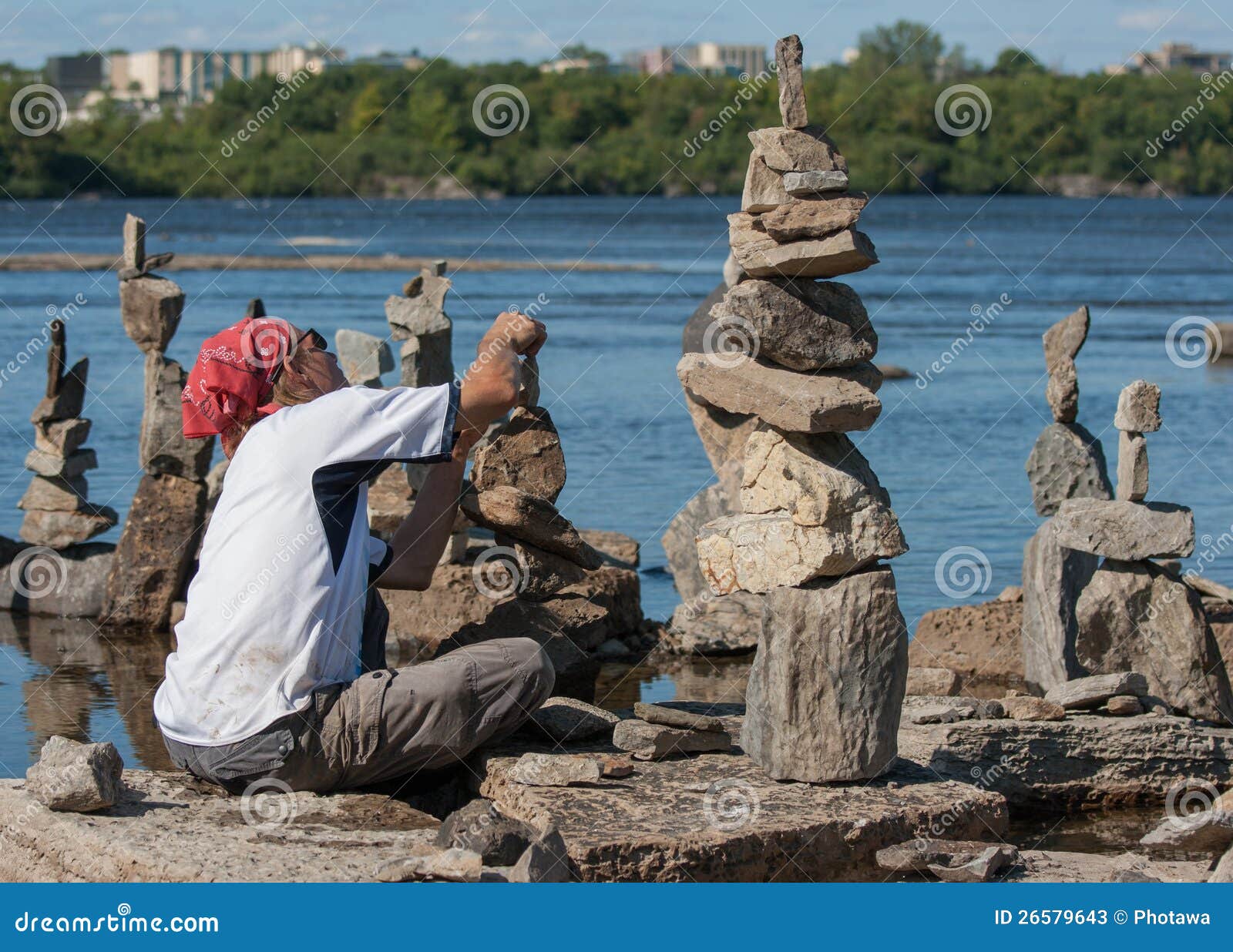 Man Stone Balancing editorial stock photo. Image of blue - 26579643