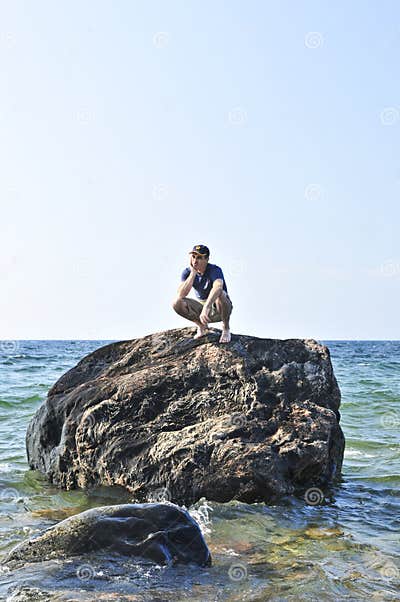 Man Stranded on a Rock in Ocean Stock Image - Image of awaiting ...