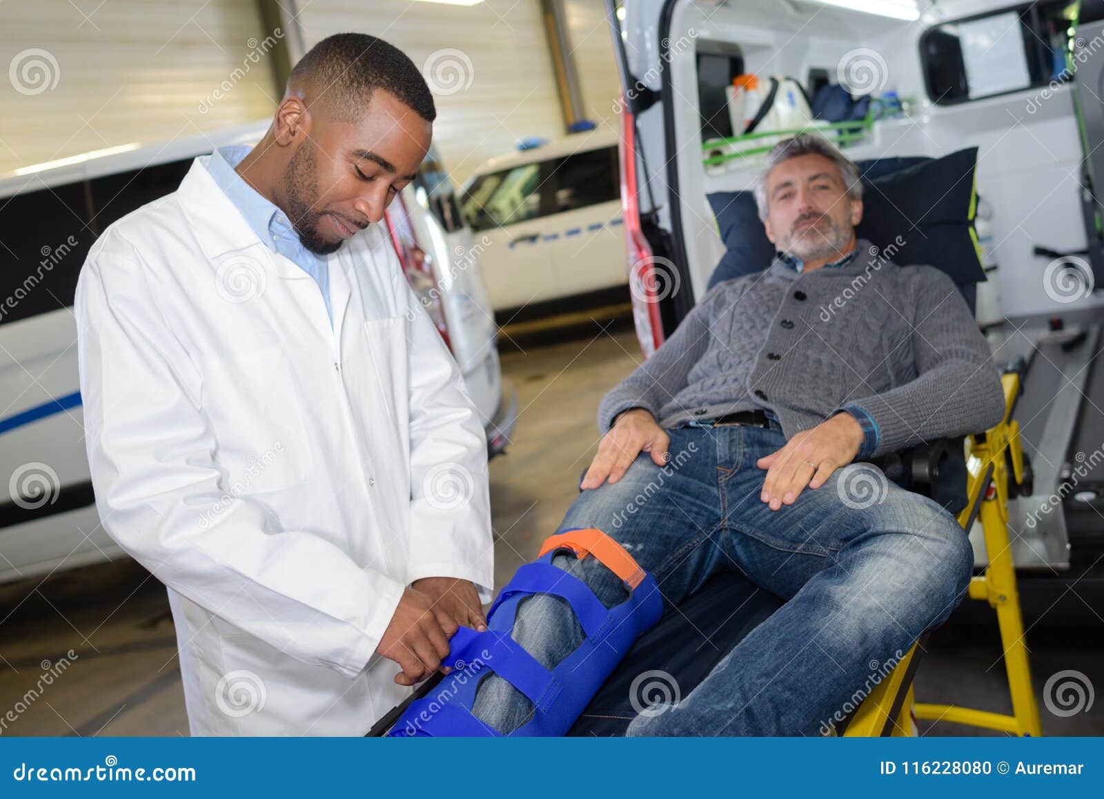 Man on Stretcher Leg in Splint Stock Photo - Image of smiling, american ...