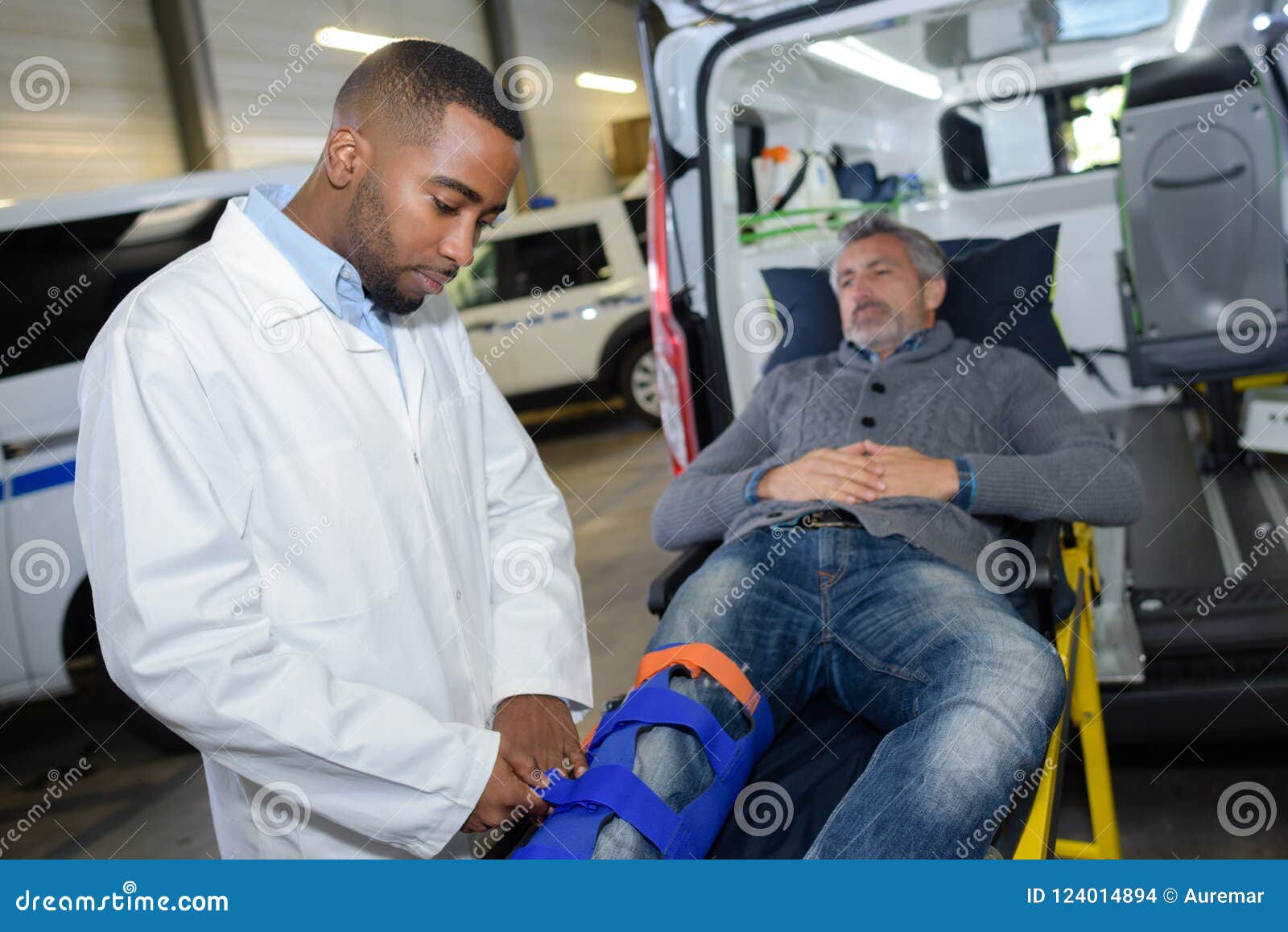 Man on Stretcher with Leg in Support Stock Photo - Image of paramedic ...