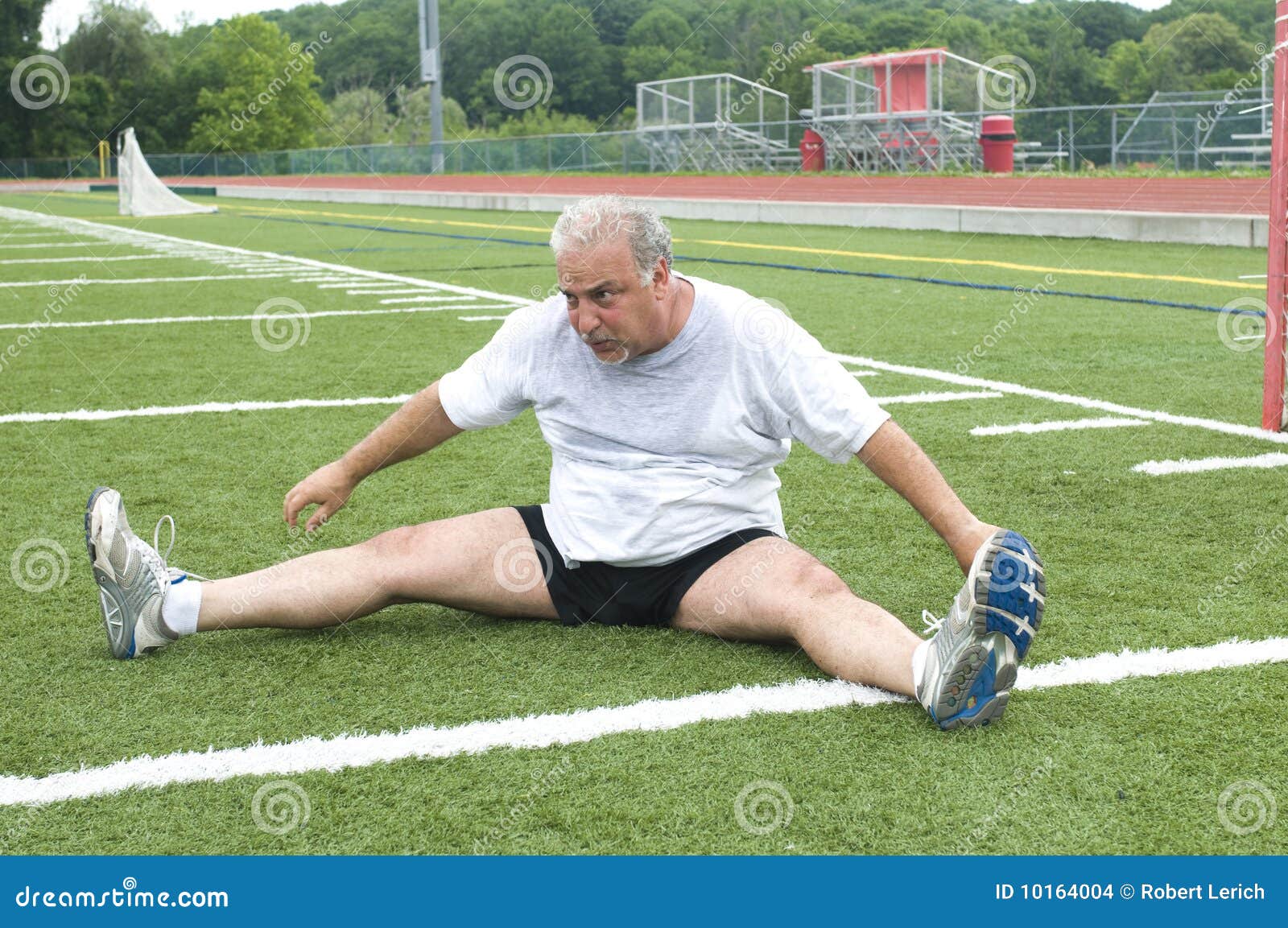 Man Stretching Exercising Sports Field Stock Photo - Image of large ...