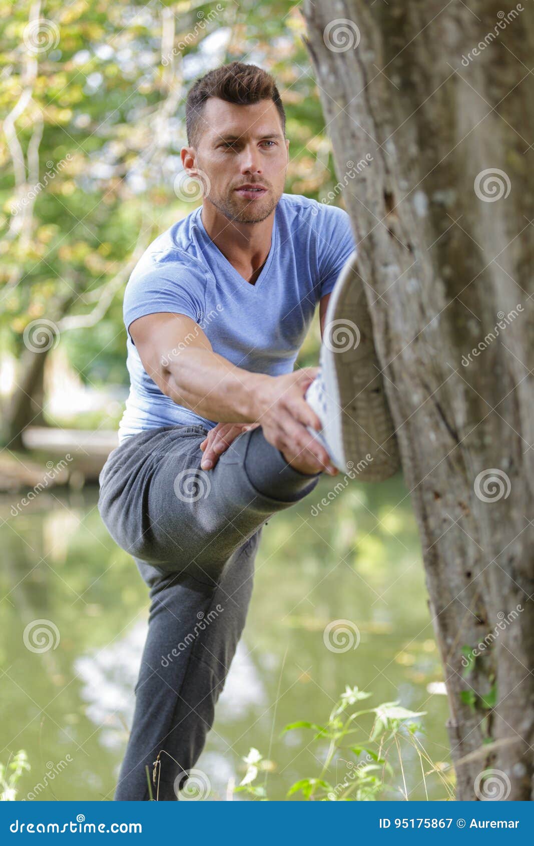 Man Stretching Out Leg Against Tree Stock Image - Image of power ...