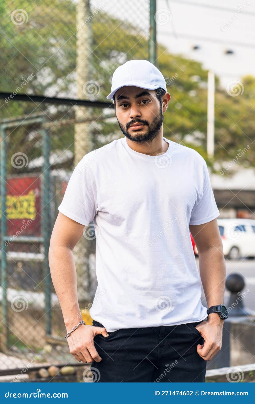 A Man Strikes a Commanding Pose in a White Blank Shirt and Cap Hat ...