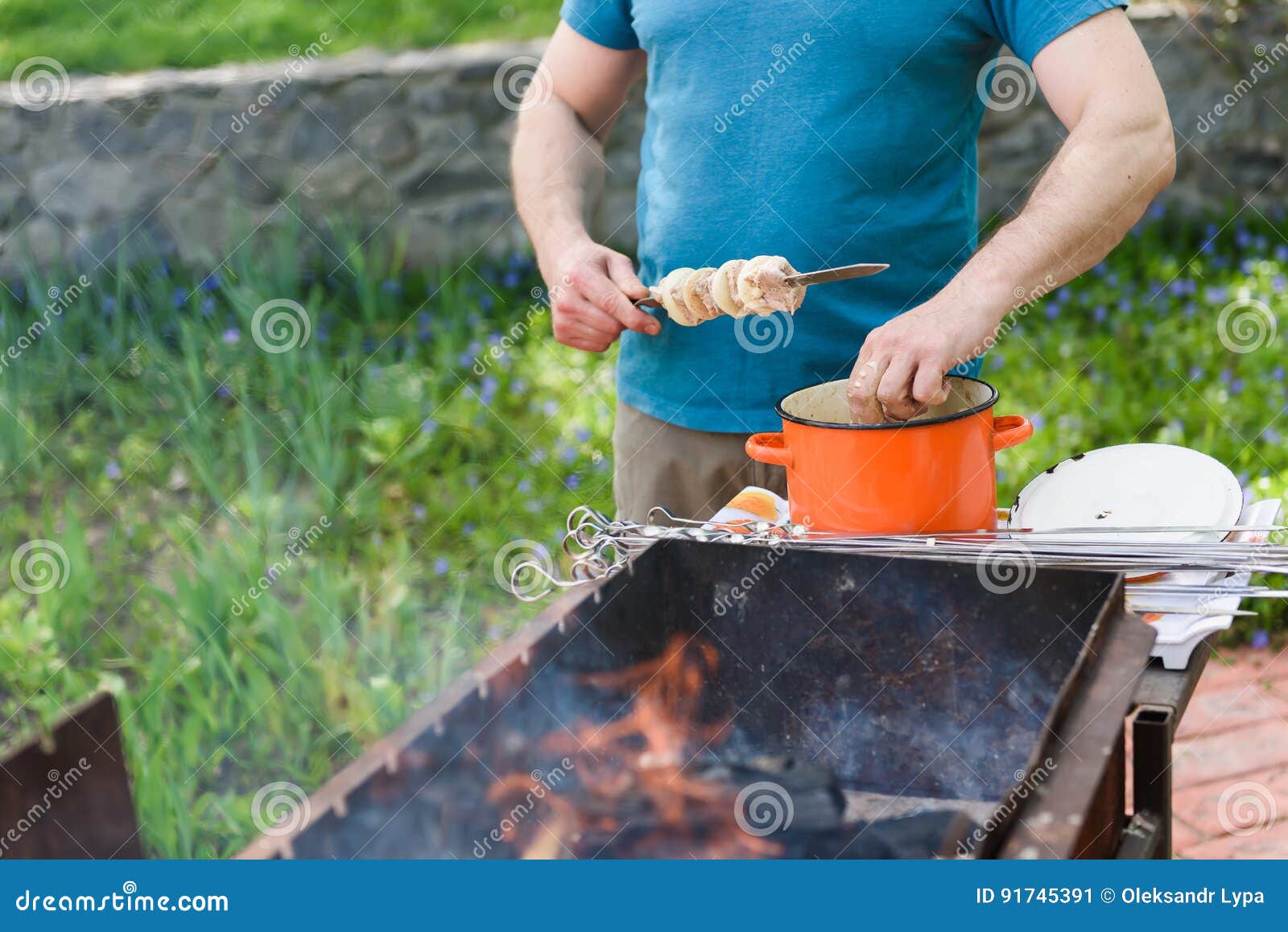 Man Stringing Meat on a Skewer Stock Image - Image of fire, food: 91745391