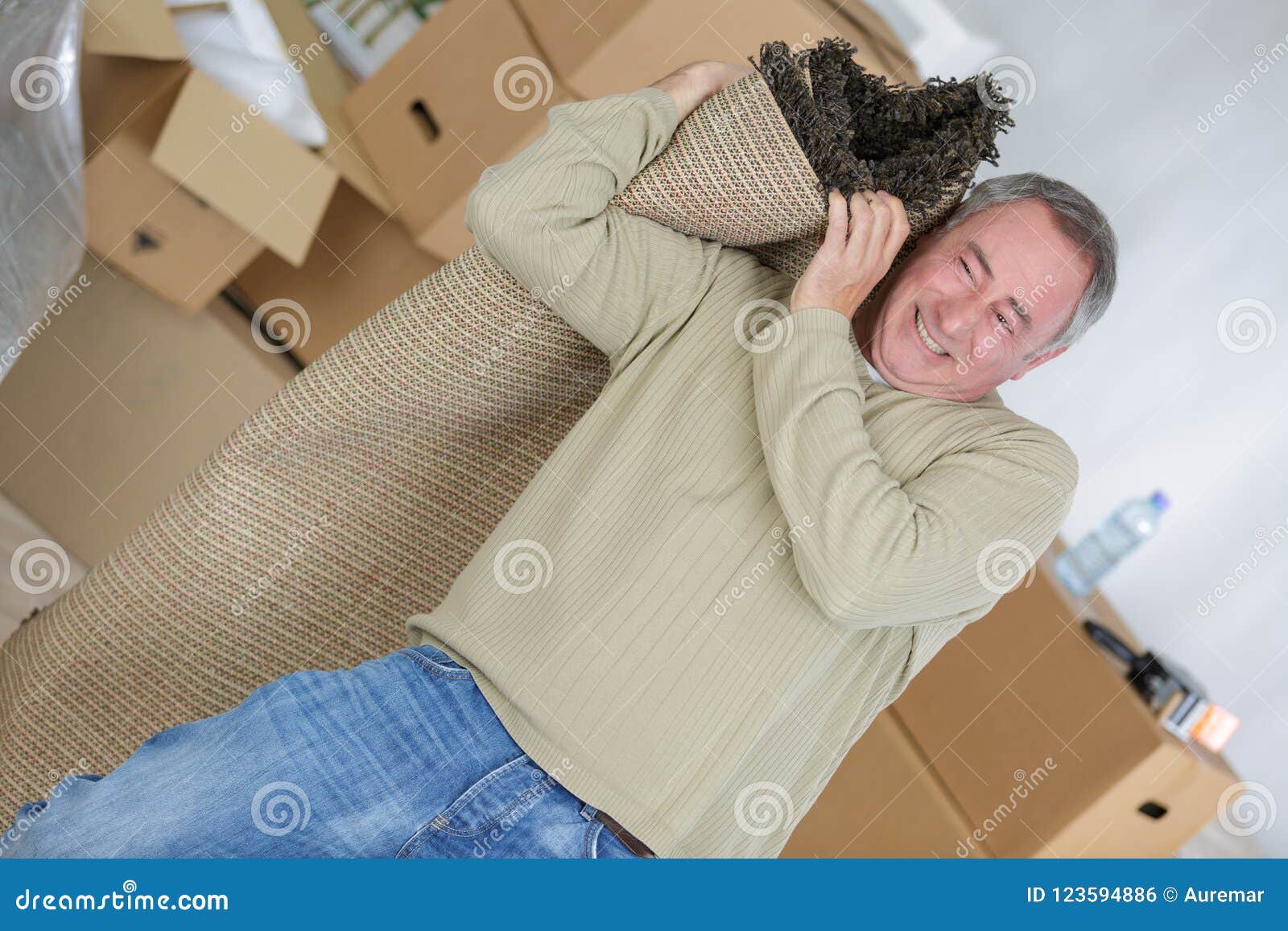 Man Struggling To Carry Rug Stock Photo - Image of business, rolled ...
