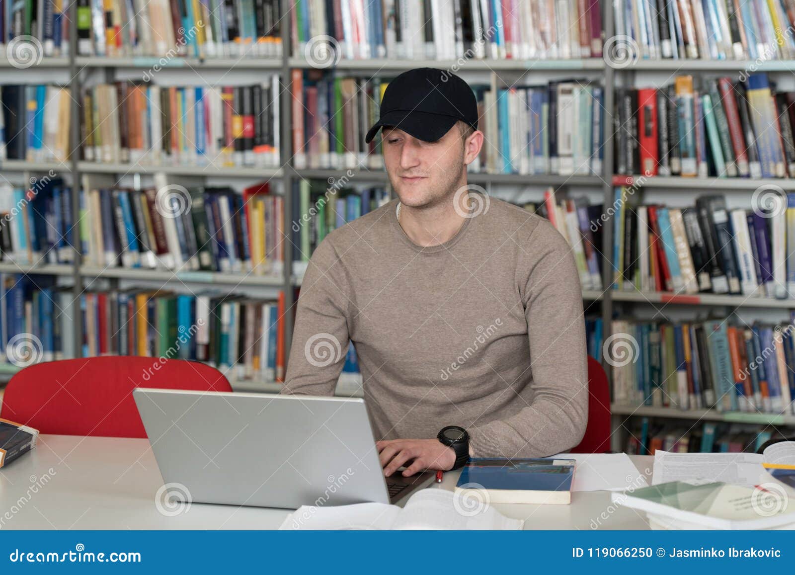 Student with Cap on Head Learning in Library Stock Photo - Image of ...