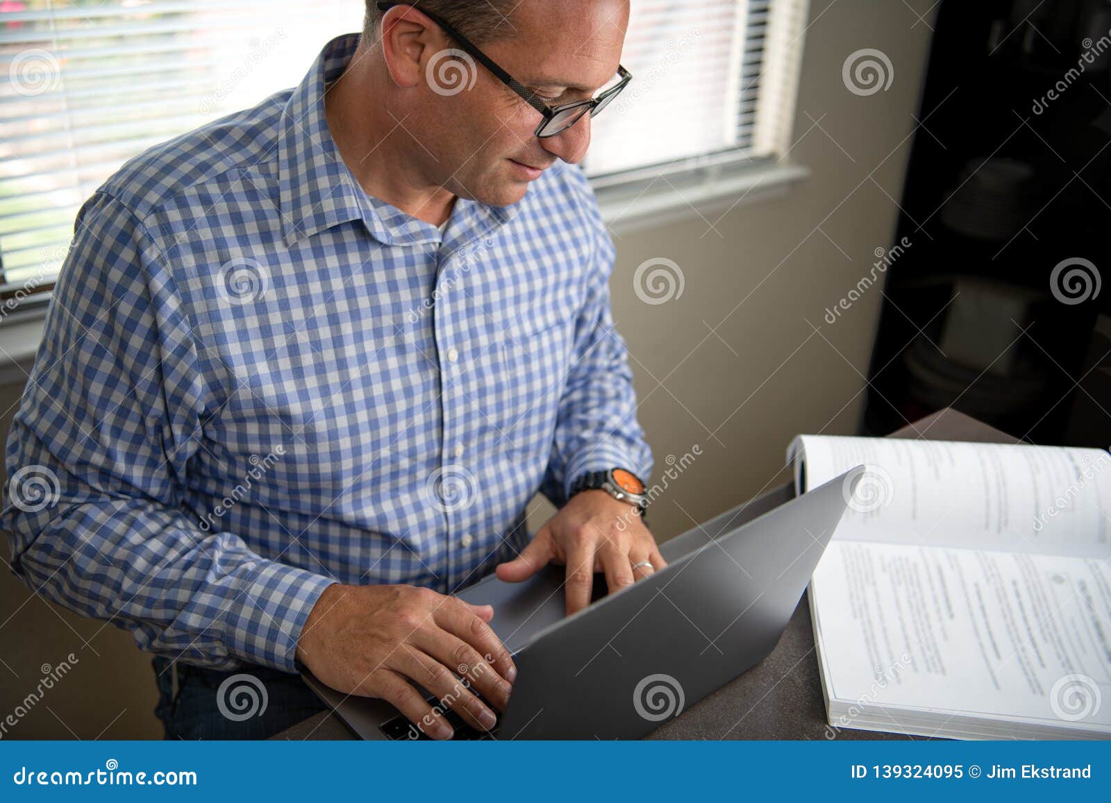Man Studying at Home Using a Laptop Computer and Textbook Stock Image ... Man Studying at Home Using a Laptop Computer and Textbook Stock Image ...